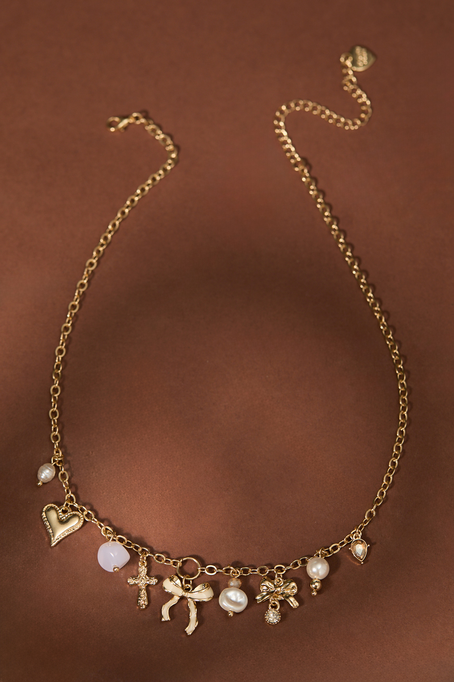 Blessed Bows Charm Necklace in Ivory & Gold | Altar'd State