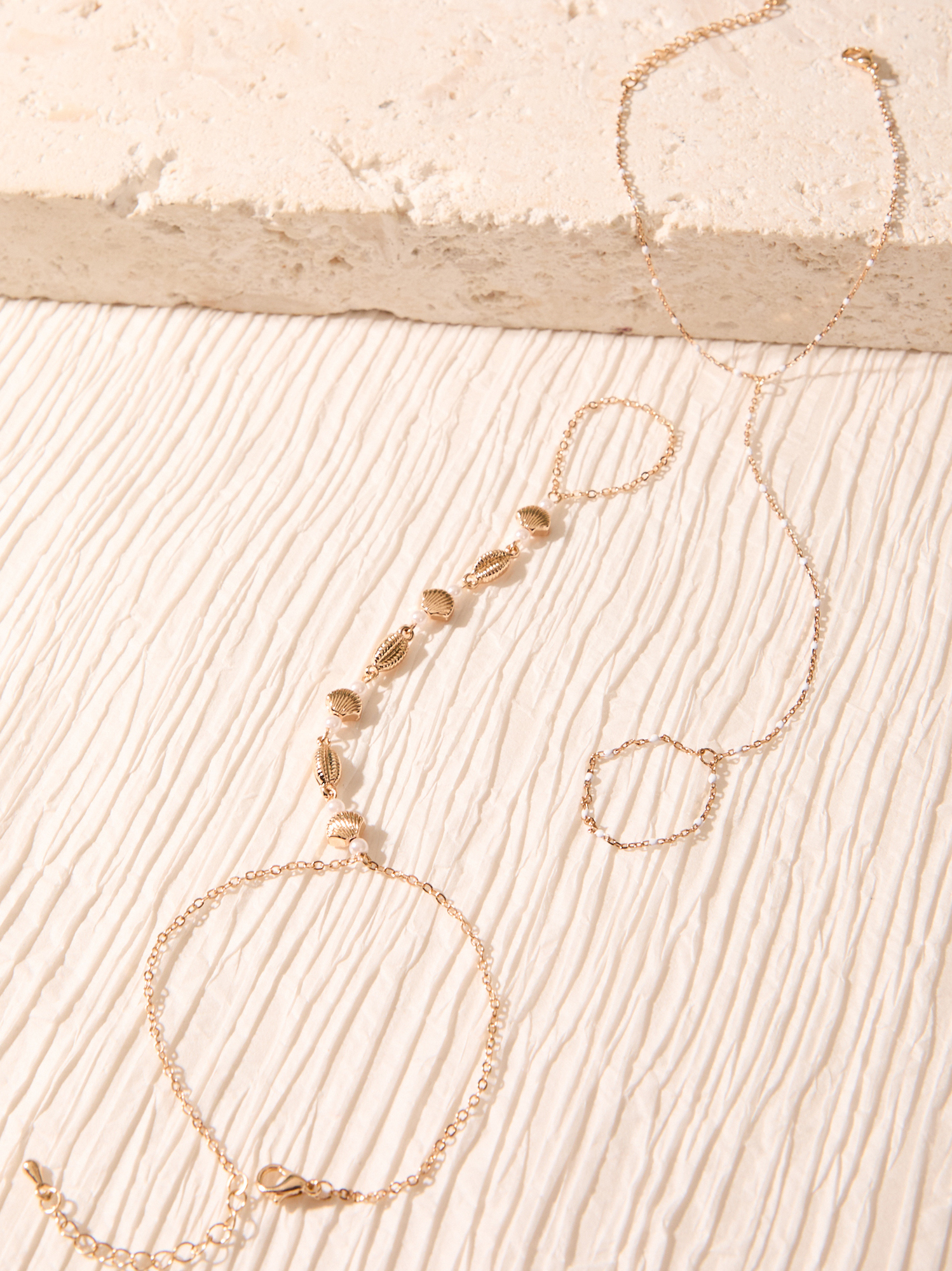 Shell Gold Hand Chain in Gold | Altar'd State