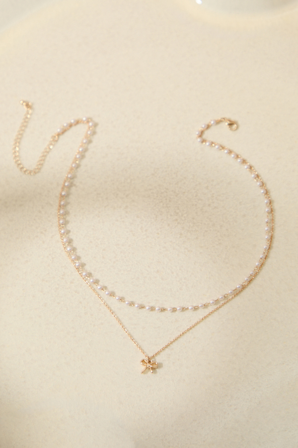 Bow Charm Pearl Layered Necklace in Gold | Altar'd State