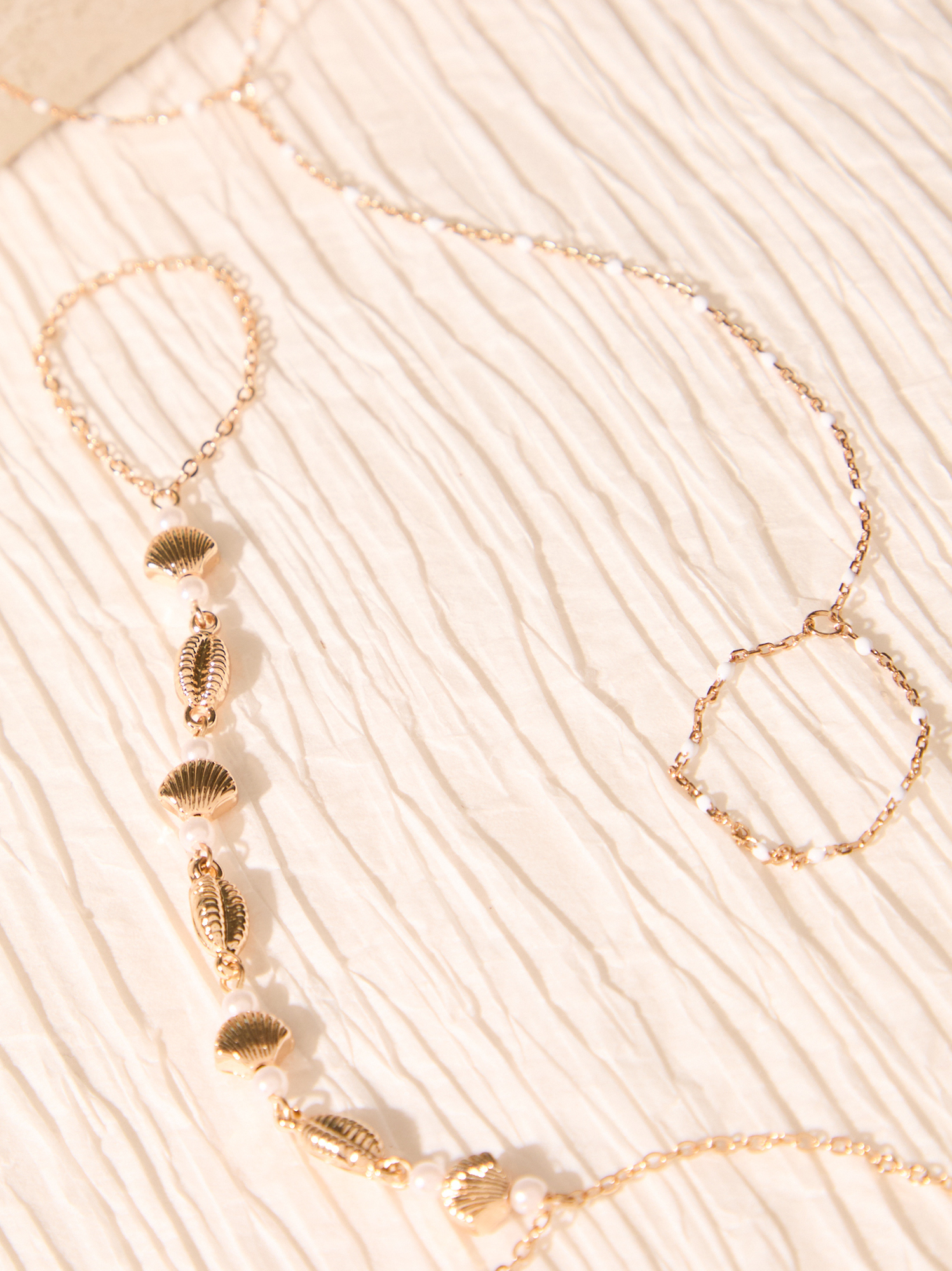 Shell Gold Hand Chain in Gold | Altar'd State